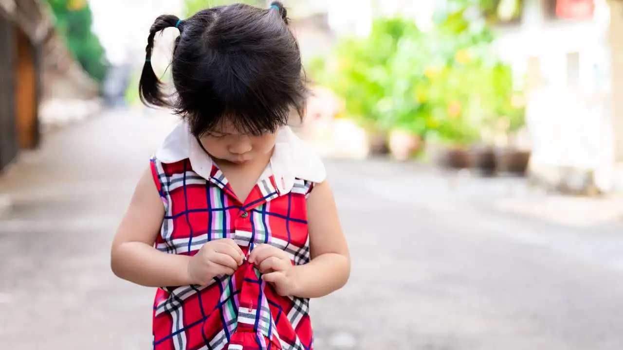 Chewing On Clothes Symptom: Why Is My Child Doing This?